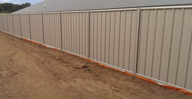 Panel fencing in trimdek profile, colour Riversand.